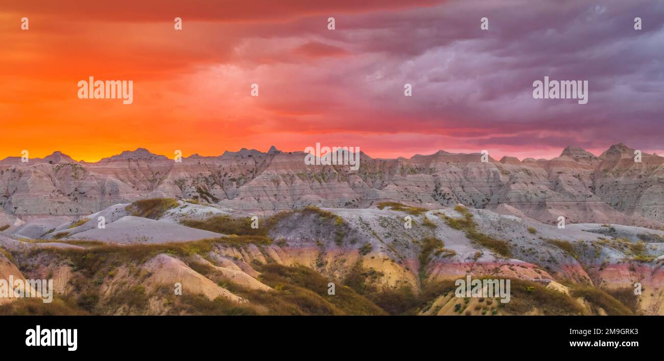 panorama of a colorful sunset over badlands in the yellow mounds area ...