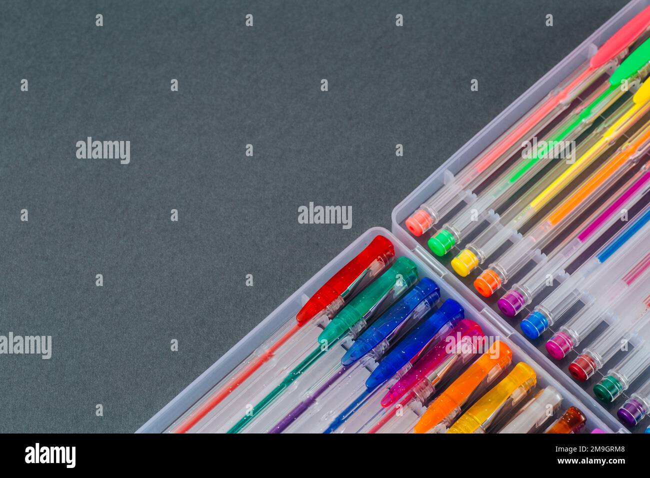 Multi-colored gel pens on a gray background Stock Photo - Alamy