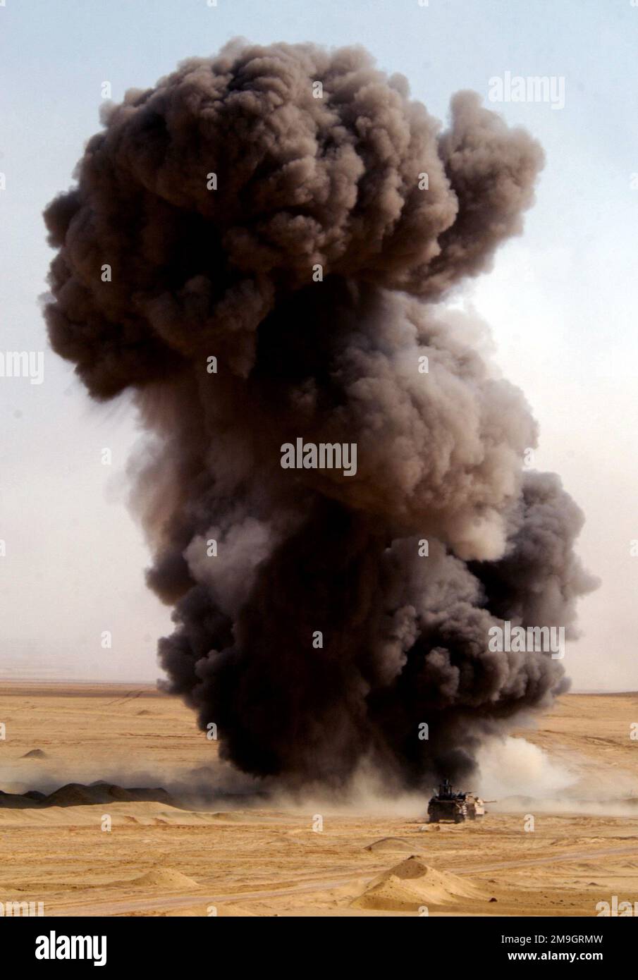 011014-F-7203T-012. [Complete] Scene Caption: From behind a Marine M1A1 ...