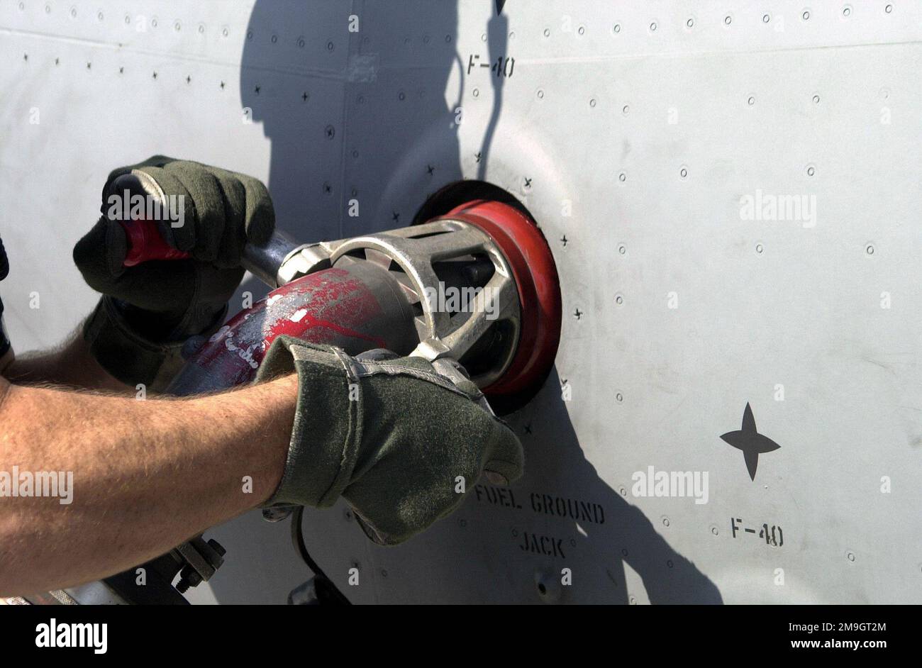 A crewchief attaches the fuel nozzle assembly to a C-17 Globemaster III ...