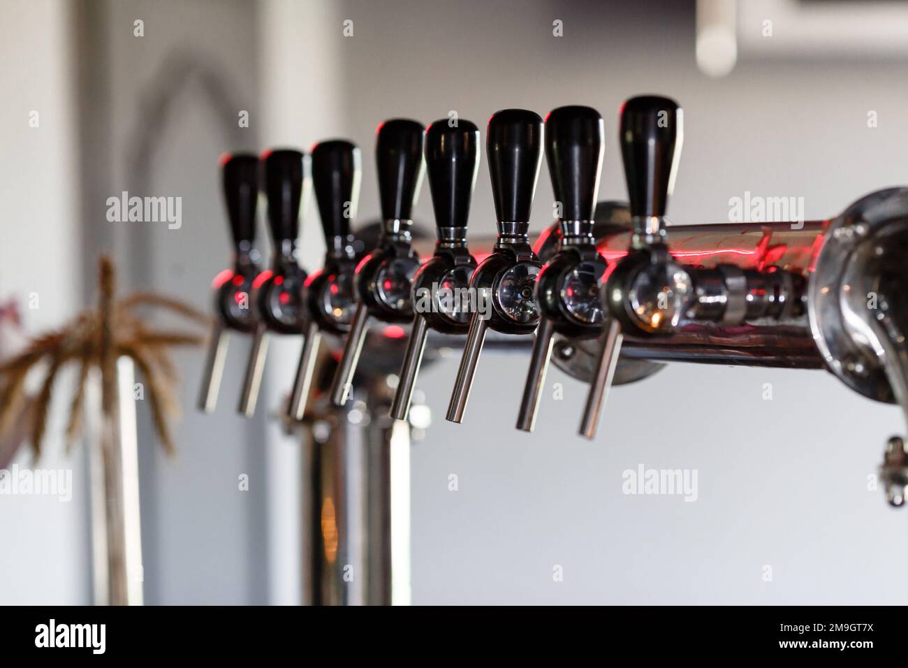 The beer taps in a pub. Alcohol concept. Pouring beer for client ...