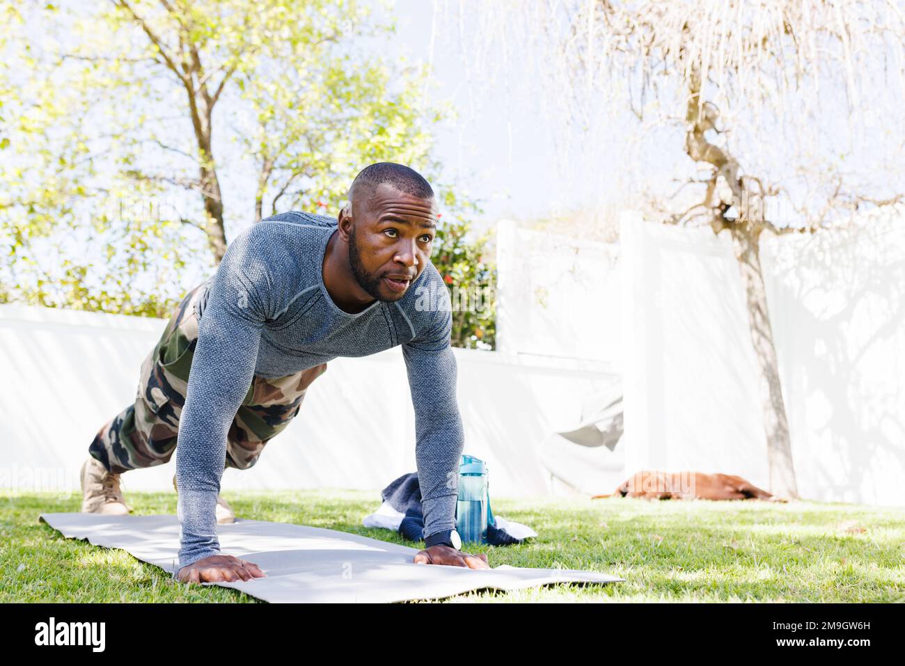 Happy african american man wearing military uniform exercising in ...