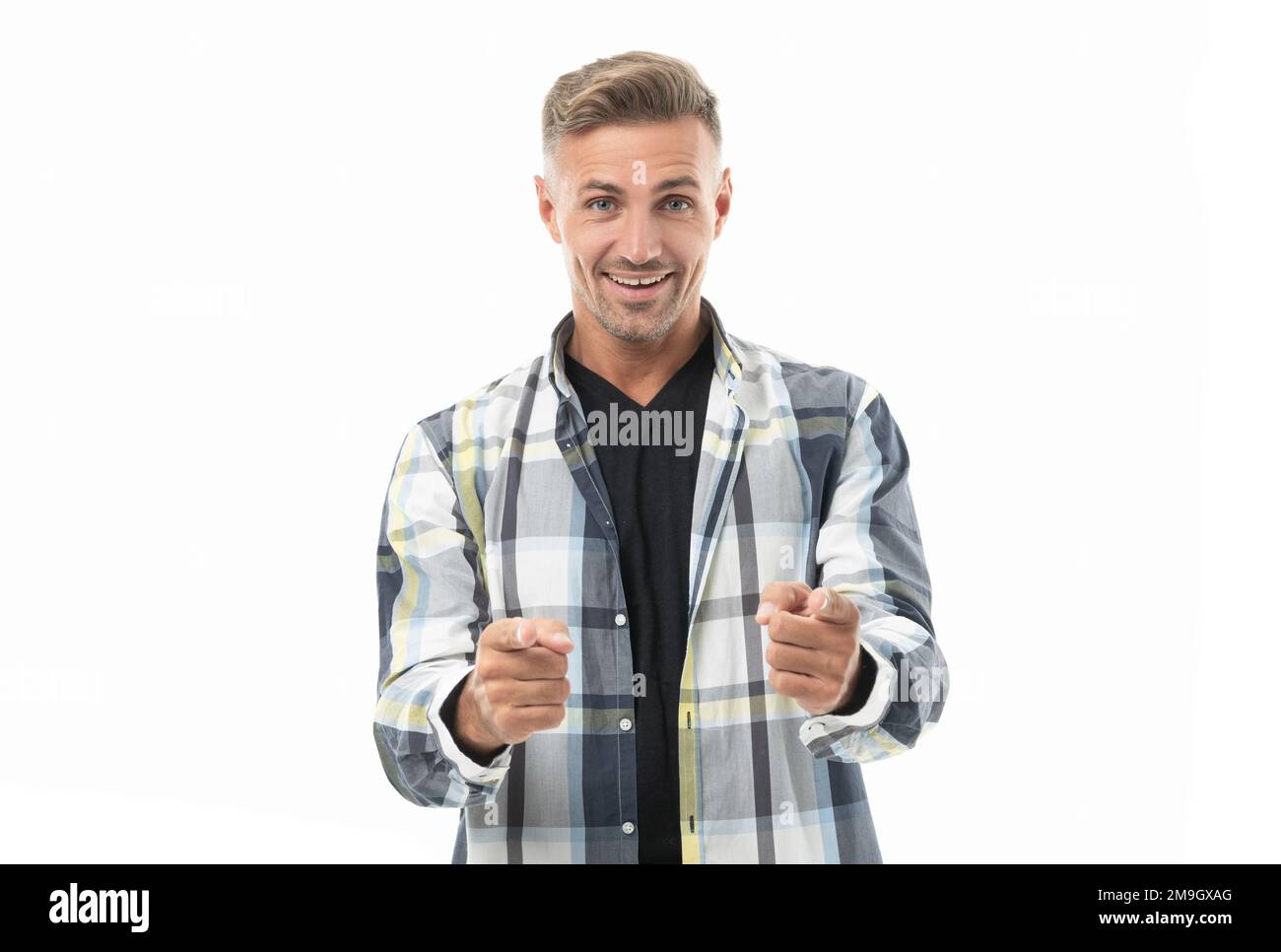 mature man pointing in studio. mature man wearing checkered shirt ...