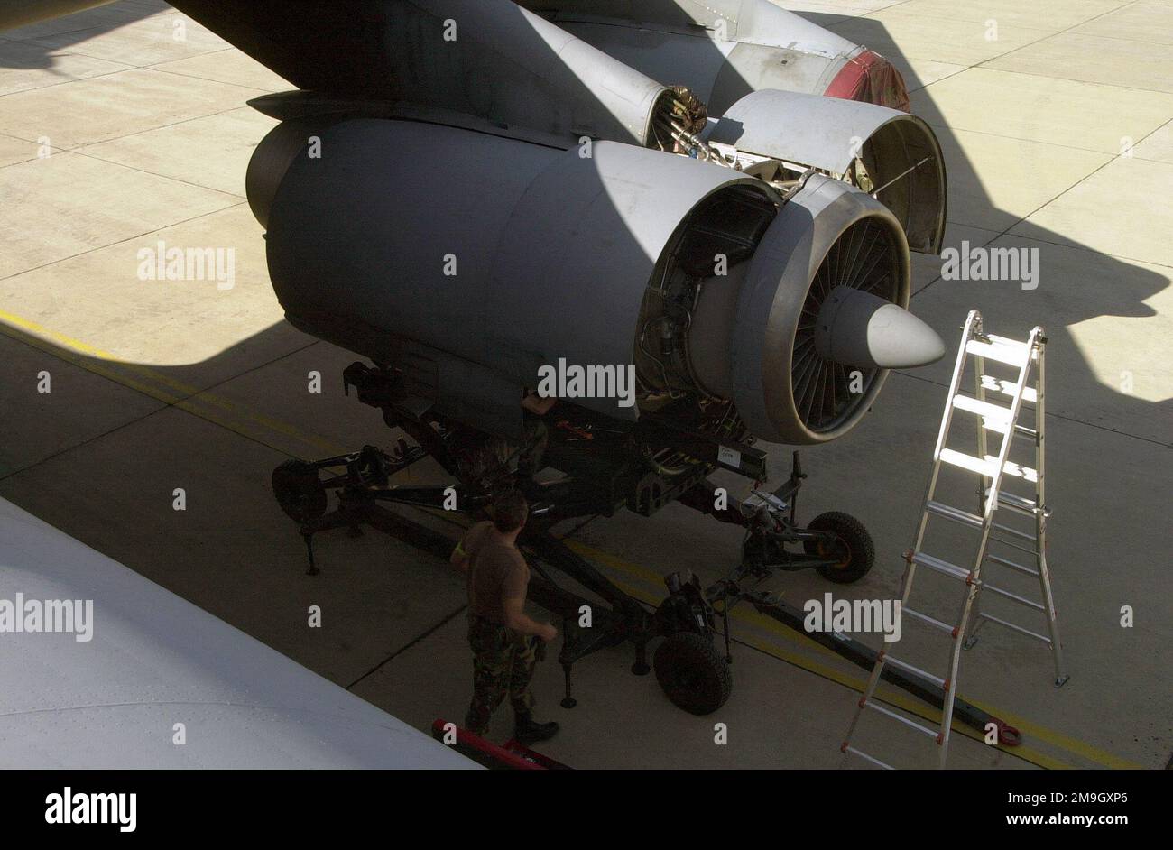 Deployed aircraft maintainers, raise into position an engine cart ...