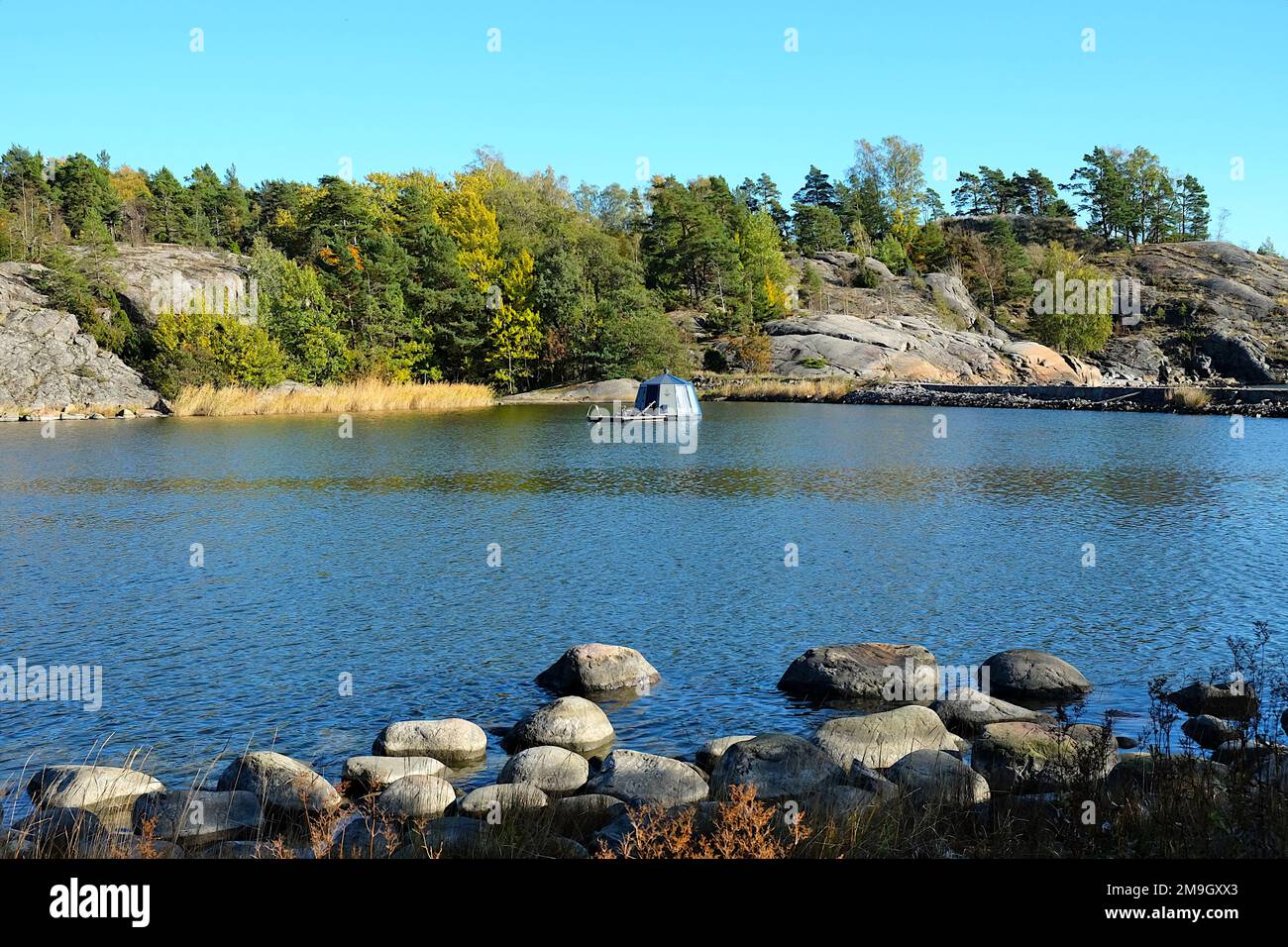 View over the strait between two islands with autumn colored trees ...