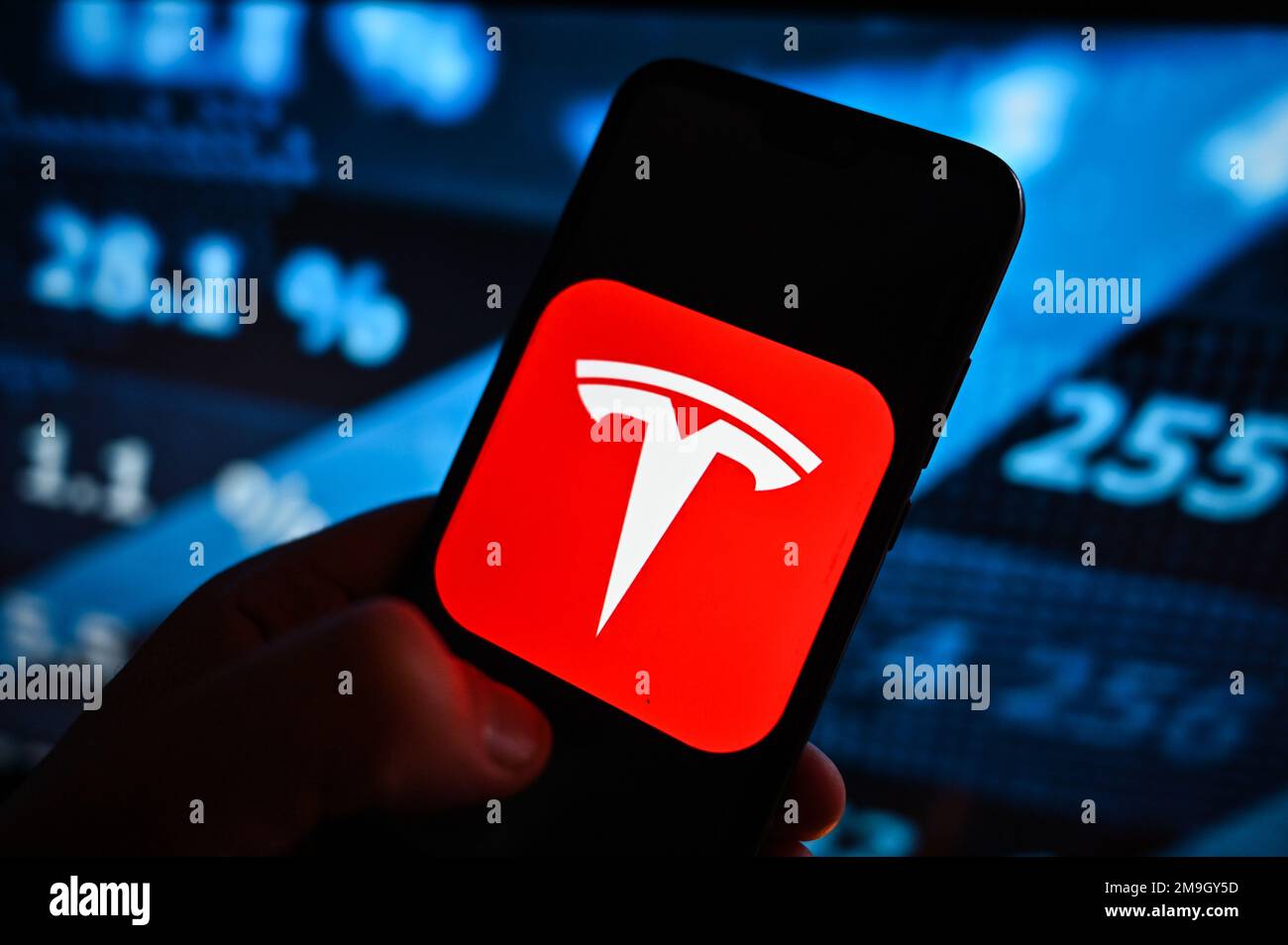 In this photo illustration a Tesla logo is displayed on a smartphone ...