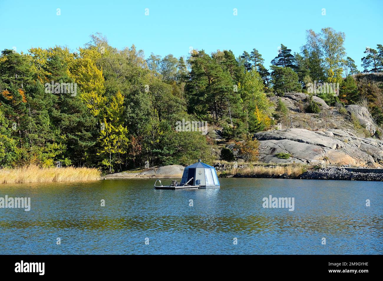 View over the strait between two islands with autumn colored trees ...