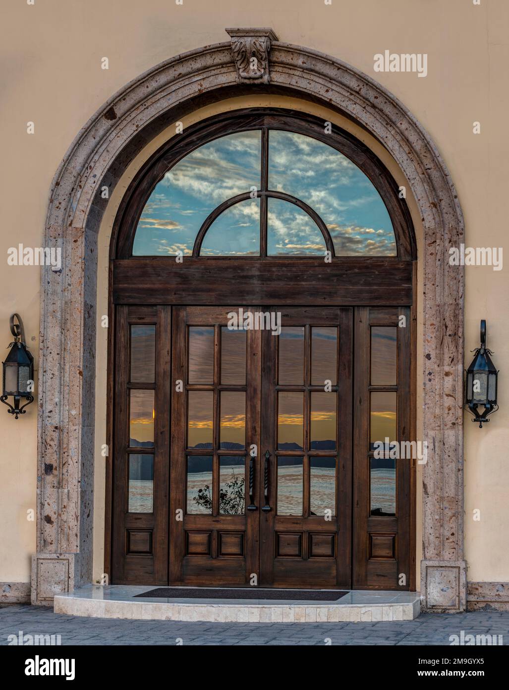 Large door with reflections of sea and sky at sunset, Baja California ...