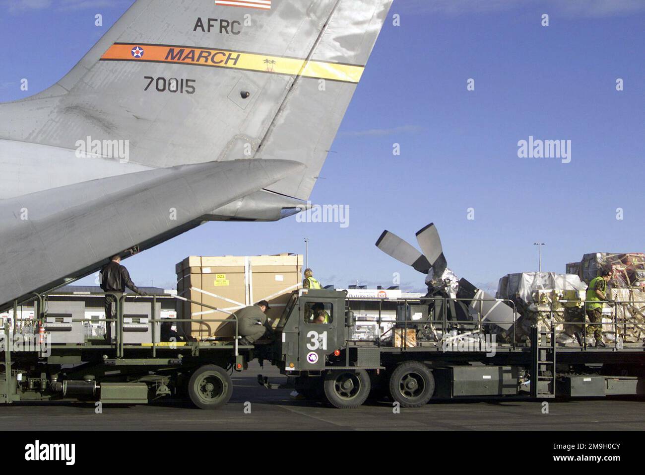 Royal New Zealand Air Force support personnel use K-loaders in tandem ...