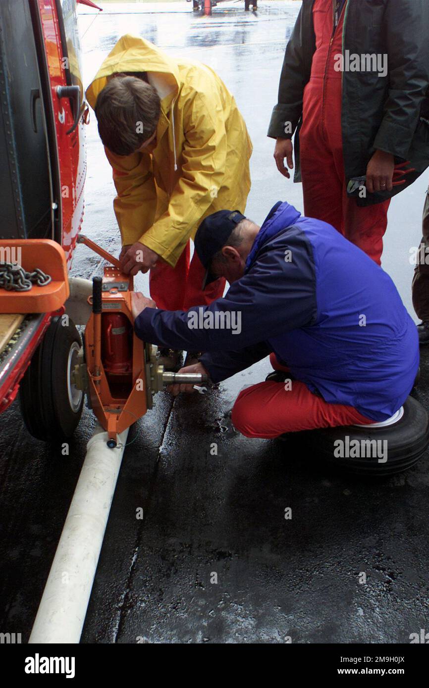 Detail photos of temporary wheels being attached to a Bell UH-1N ...