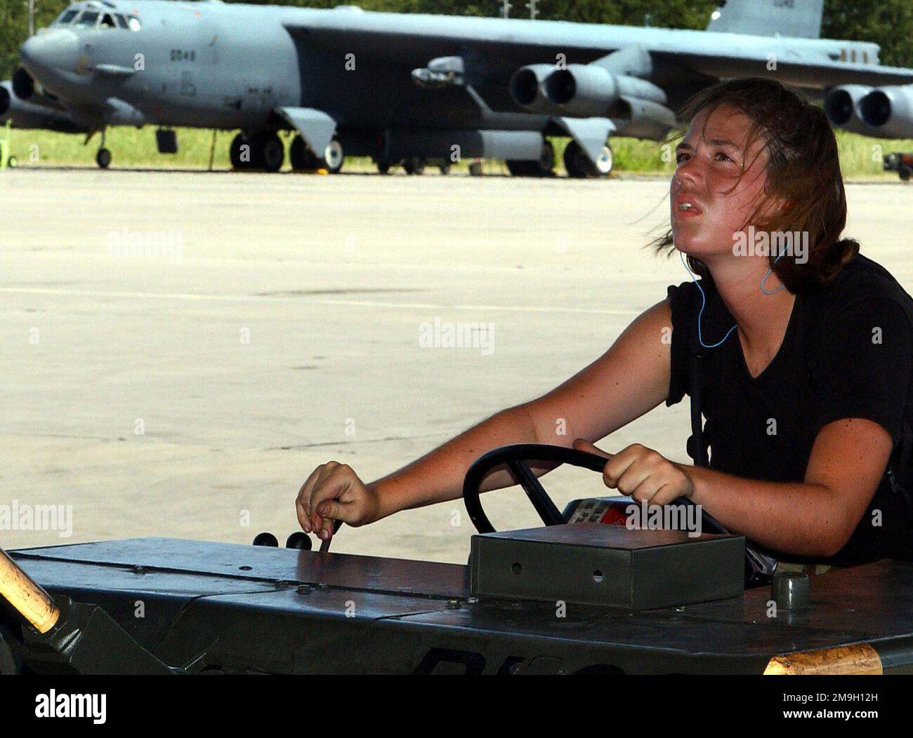 With a B-52 Stratofortress as a backdrop, an Air Force Load crewmember ...