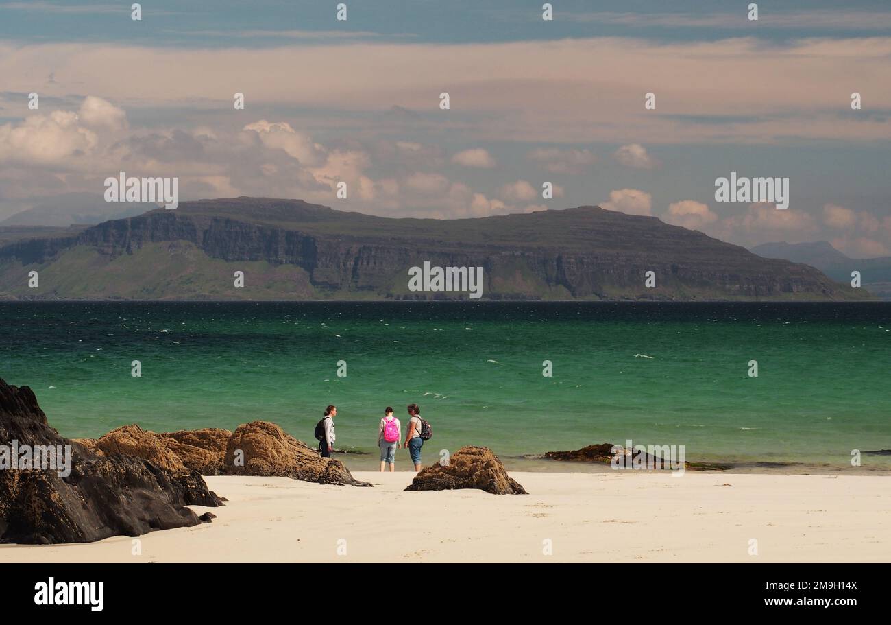 Three young women on White Strand of the Monk's beach Iona, Scotland UK ...
