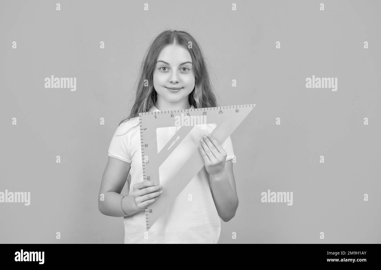 smiling child with math triangle measuring tool Stock Photo - Alamy
