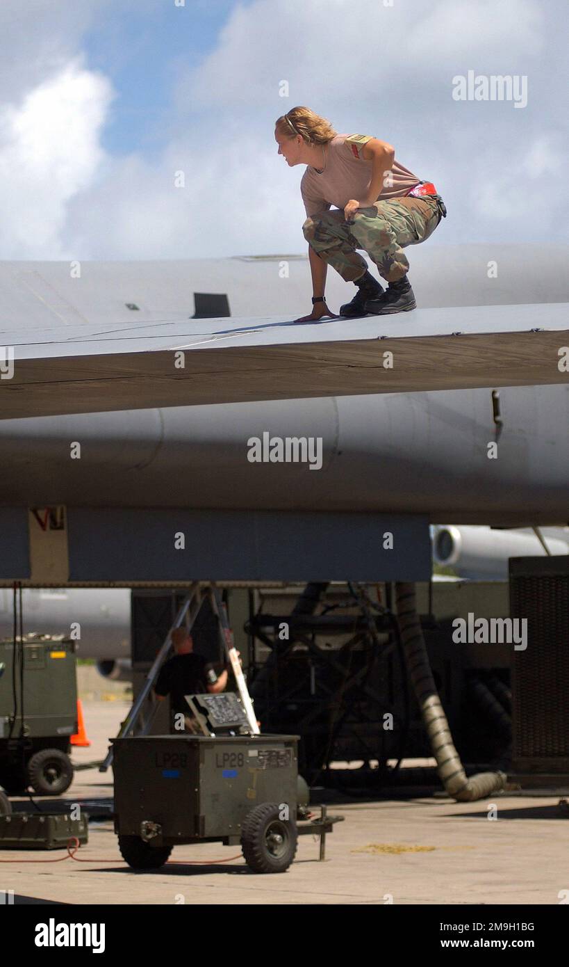 011106-F-2034C-010. [Complete] Scene Caption: An Air Force crewchief ...