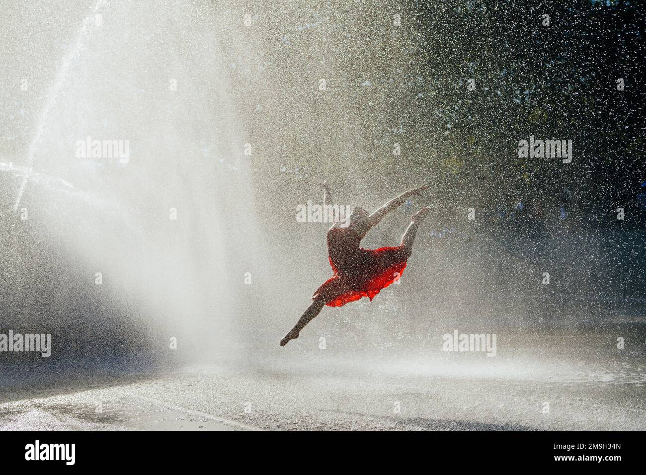 Ballet dancer in red dress dancing in fountain, International Fountain ...