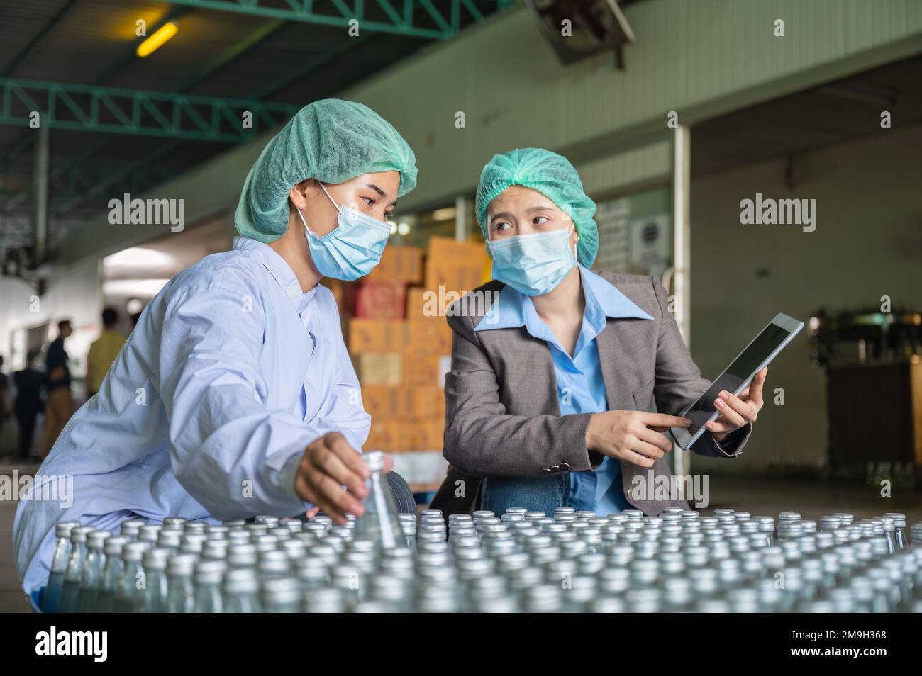 Asian inspector supervisor woman with assistant employee wearing in ...