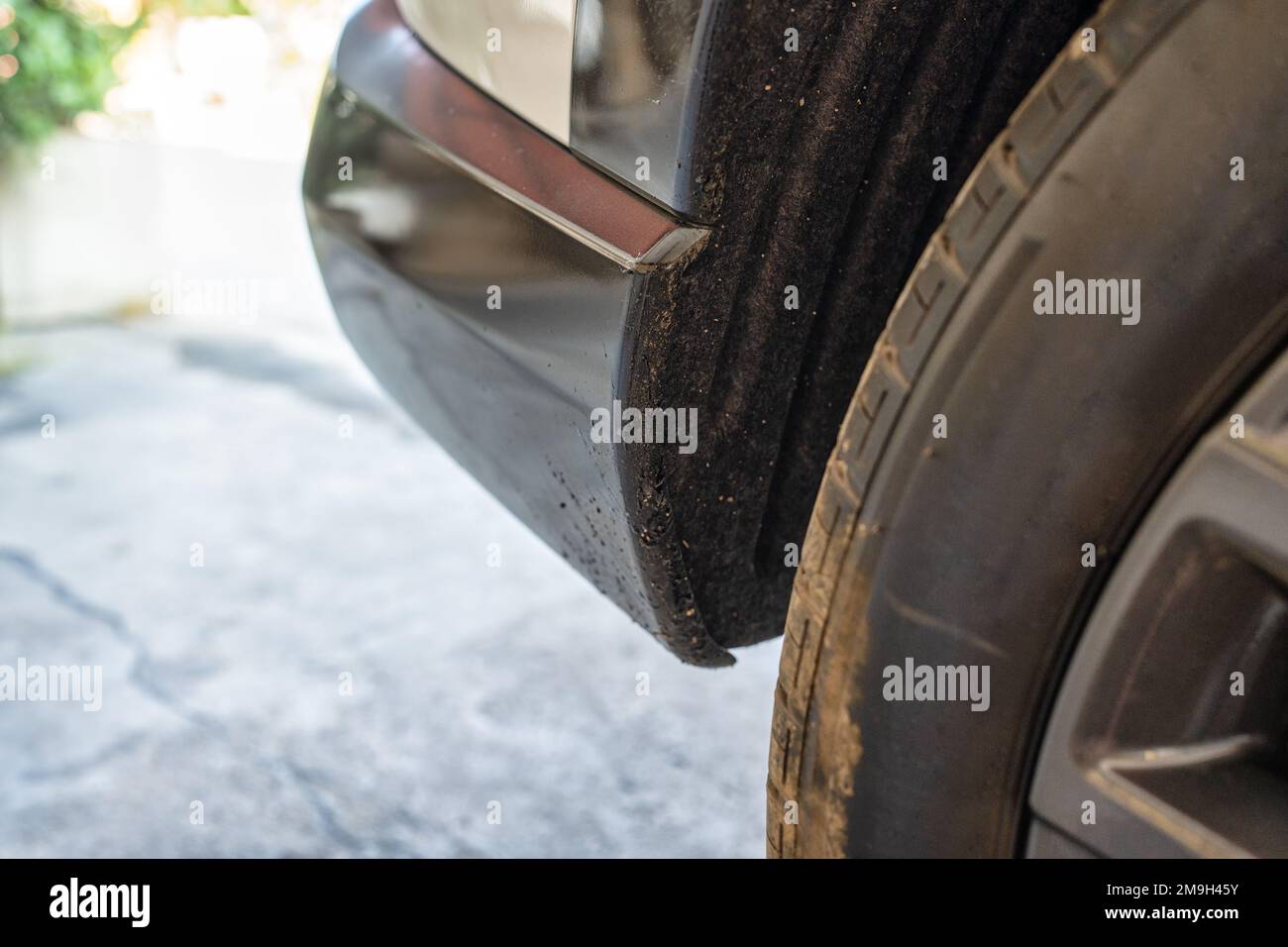 Tarmac and mud stains on rear of black plastic bumper car parked Stock ...