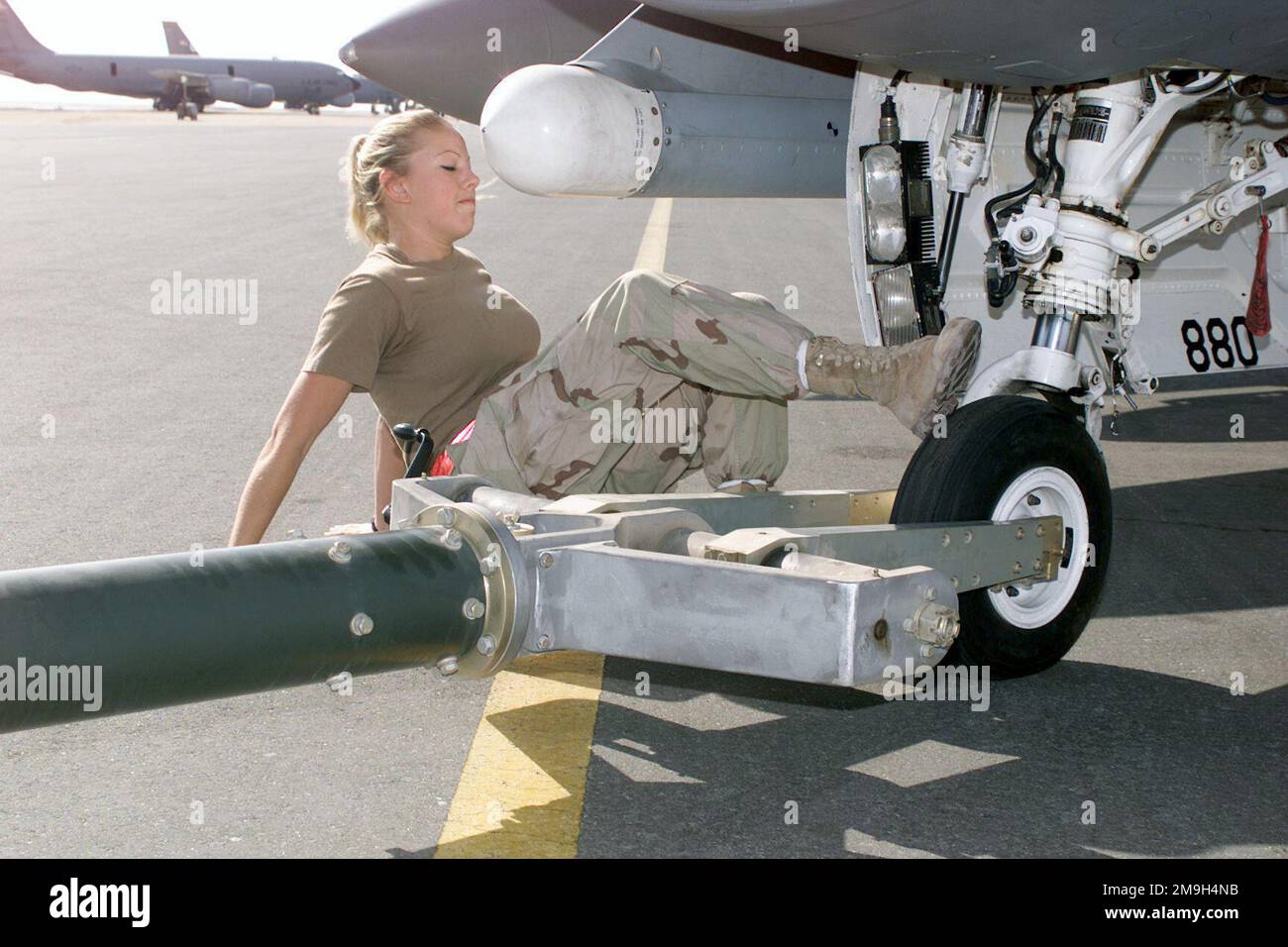 AIRMAN First Class (A1C) Danicka Jensen, a Crew CHIEF, kicks the tire ...