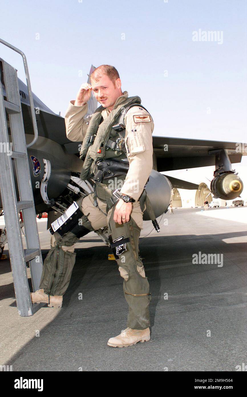 Captain Brett "Zipper" Robinson stands next to his F-16 Fighting Falcon ...