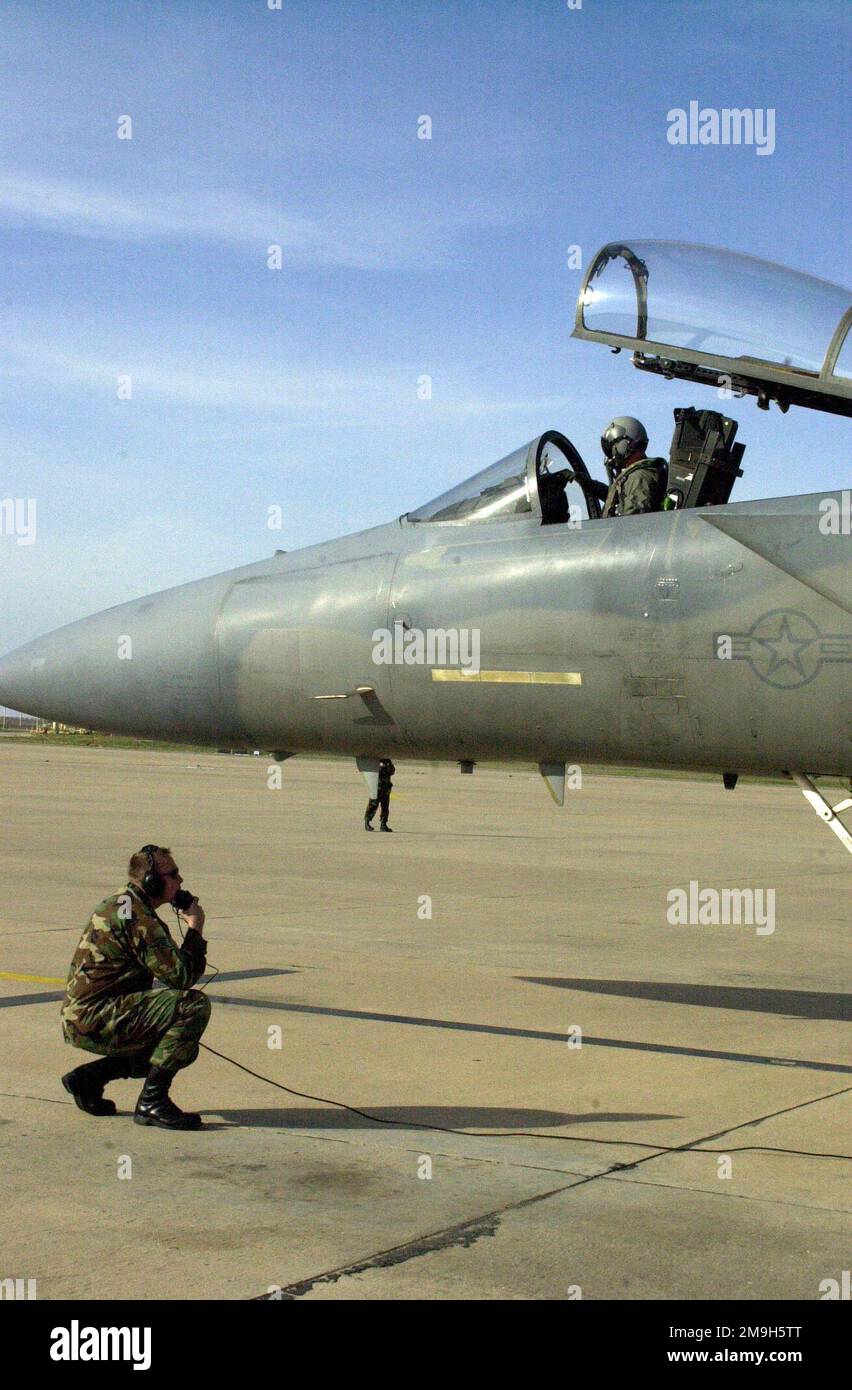 A crew chief communicates with an F-15C Eagle fighter pilot prior to ...
