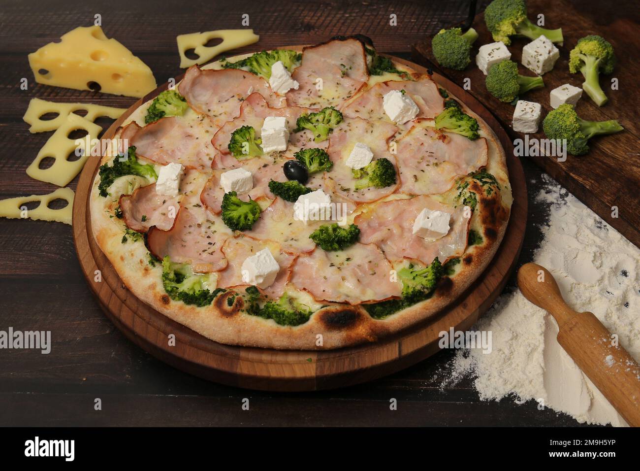 A high angle shot of a gourmet pizza with various toppings on a messy ...