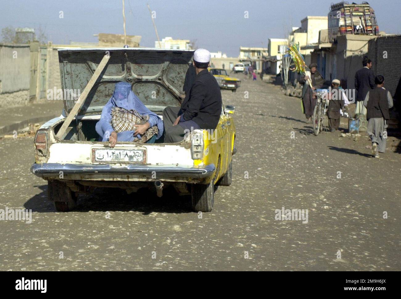 Local Afghanis taxi at the Mazar-e Sharif airfield, in support of ...