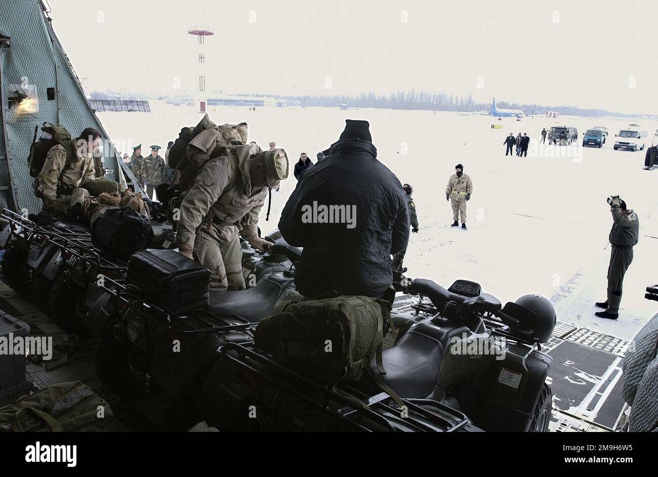 United States Air Force Reserve aircrew members offload snowmobiles and ...