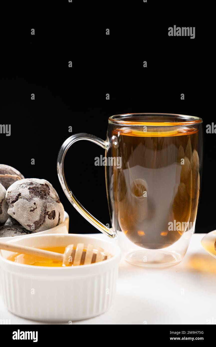 A cup of strong black tea, a glass large cup with a double bottom on a ...