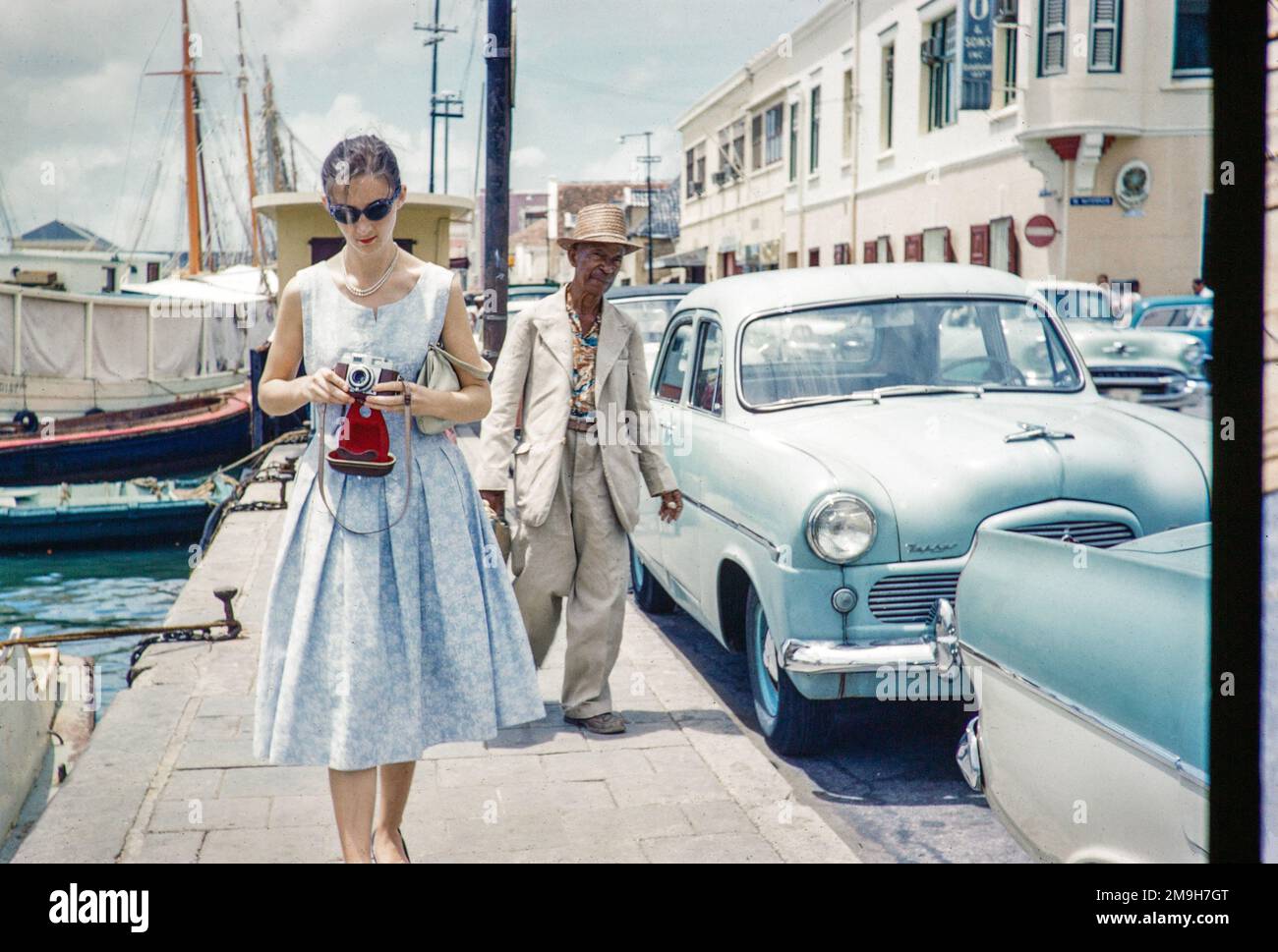 Female tourist taking photo at fishing harbour, Willemstad, Curacao ...