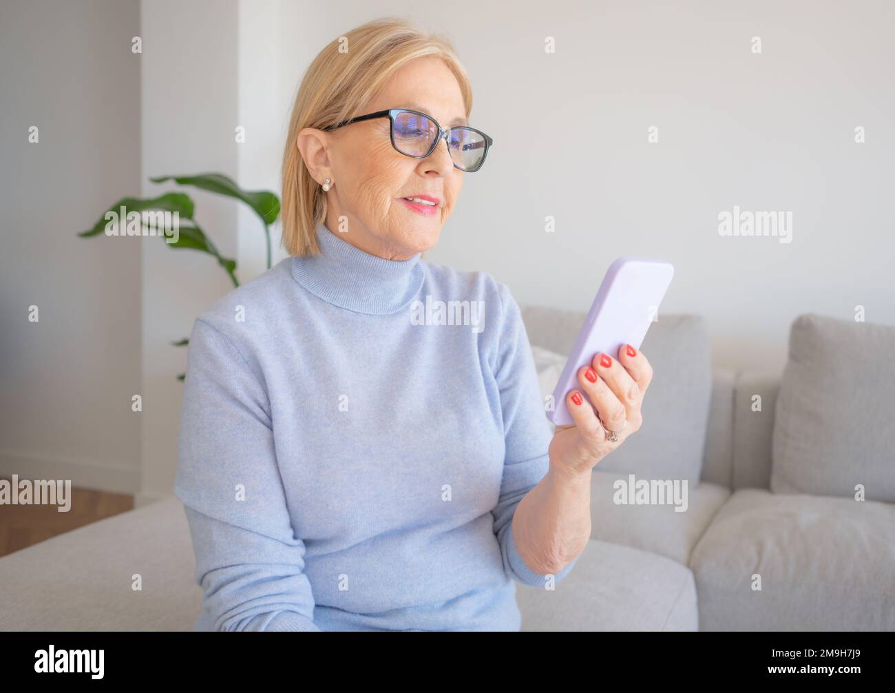 Relaxed mature old 60s woman, older middle aged female customer holding ...
