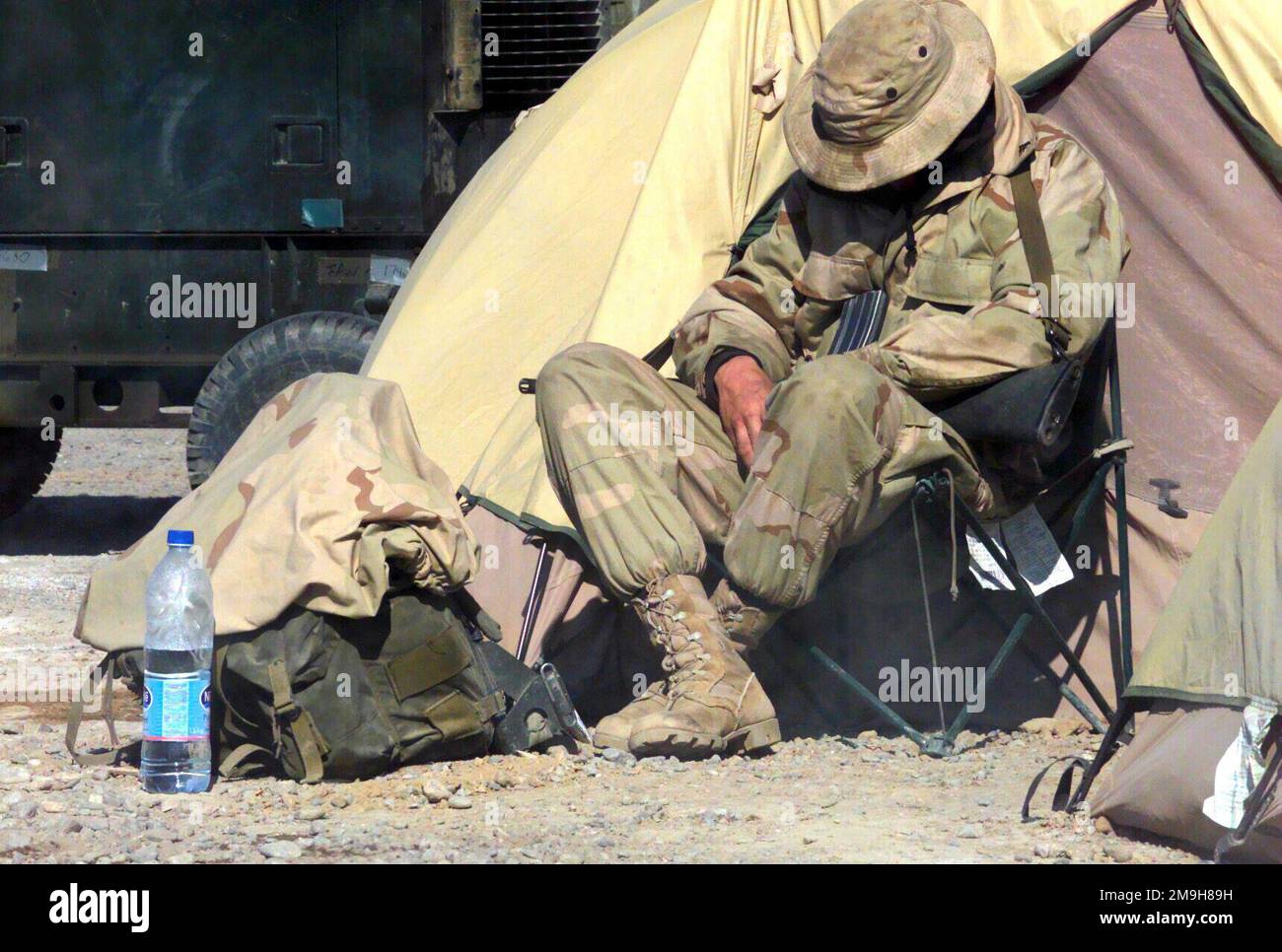 Living up to a military maxim - if you can sleep, sleep. With an M-16 ...