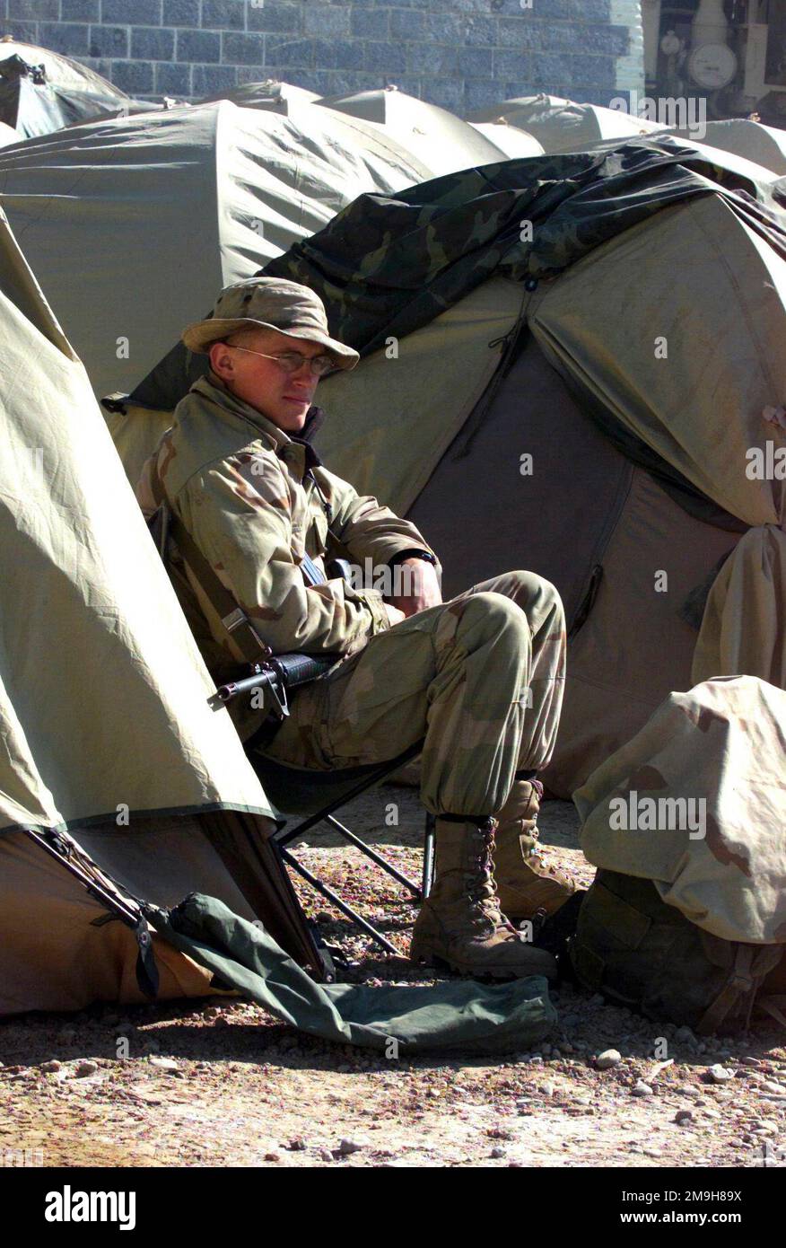 With an M-16 across his lap, Lance Corporal K. A. Heaps, USMC, from ...