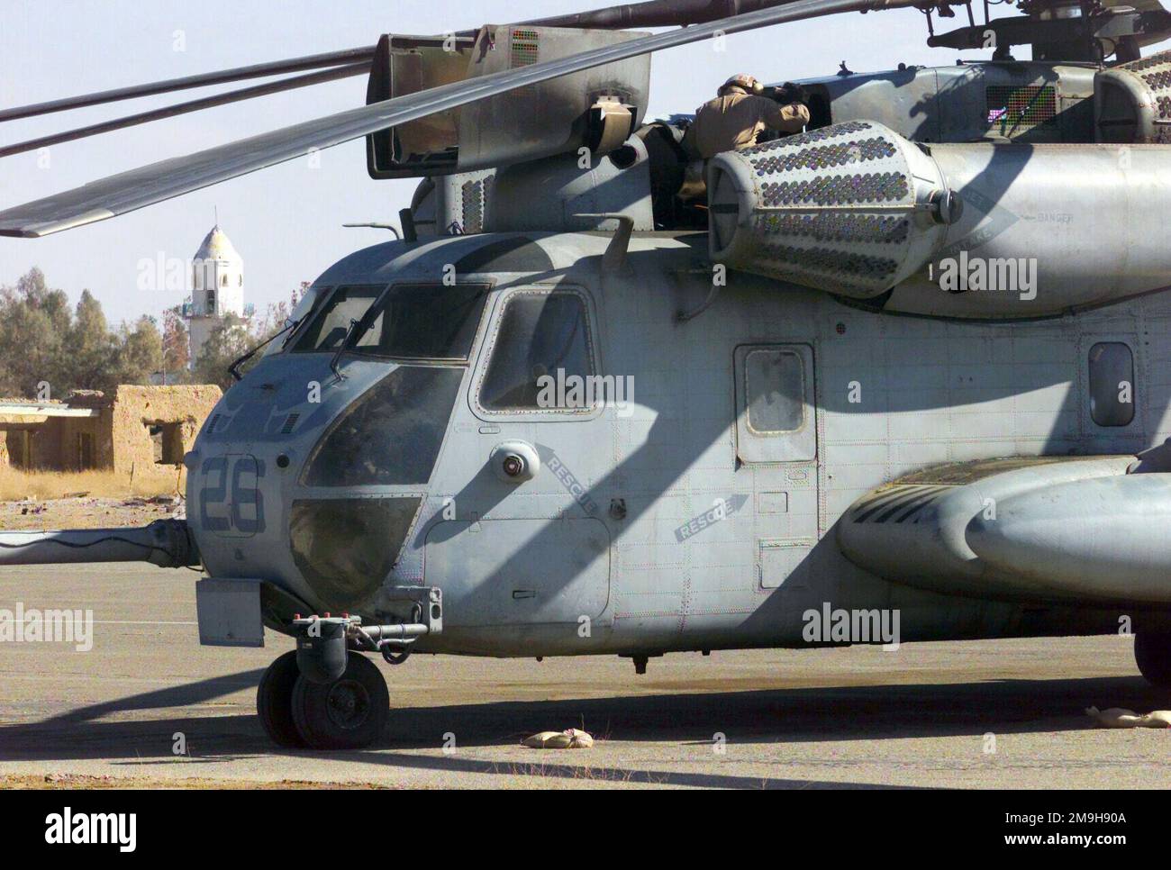 A Marine performs preventive maintenance on a CH-53 Sea Stallion ...