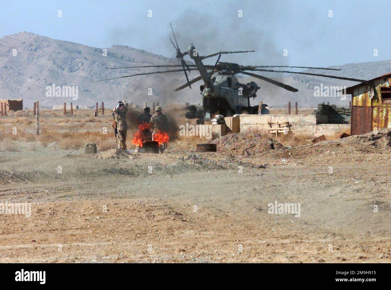 Military personnel burn latrine waste in 50 gallon drums outside the ...