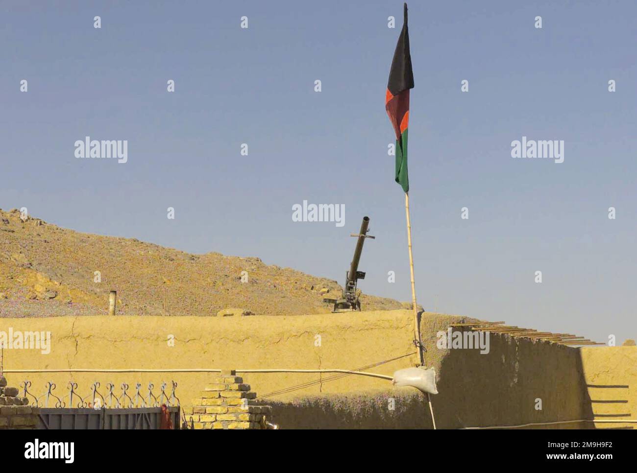 With the new Afghanistan flag flying in the foreground, a mortar tube ...