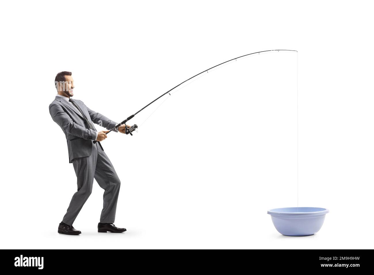 Full length profile shot of a businessman fishing in a wash basin ...