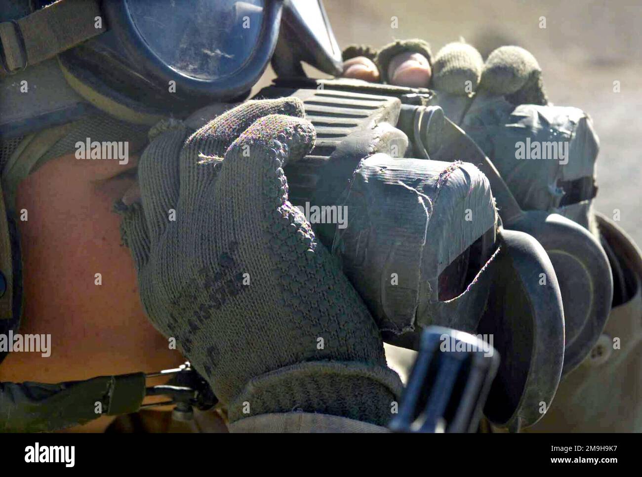 Checking out the distant area, Corporal David Easter, USMC, peers ...