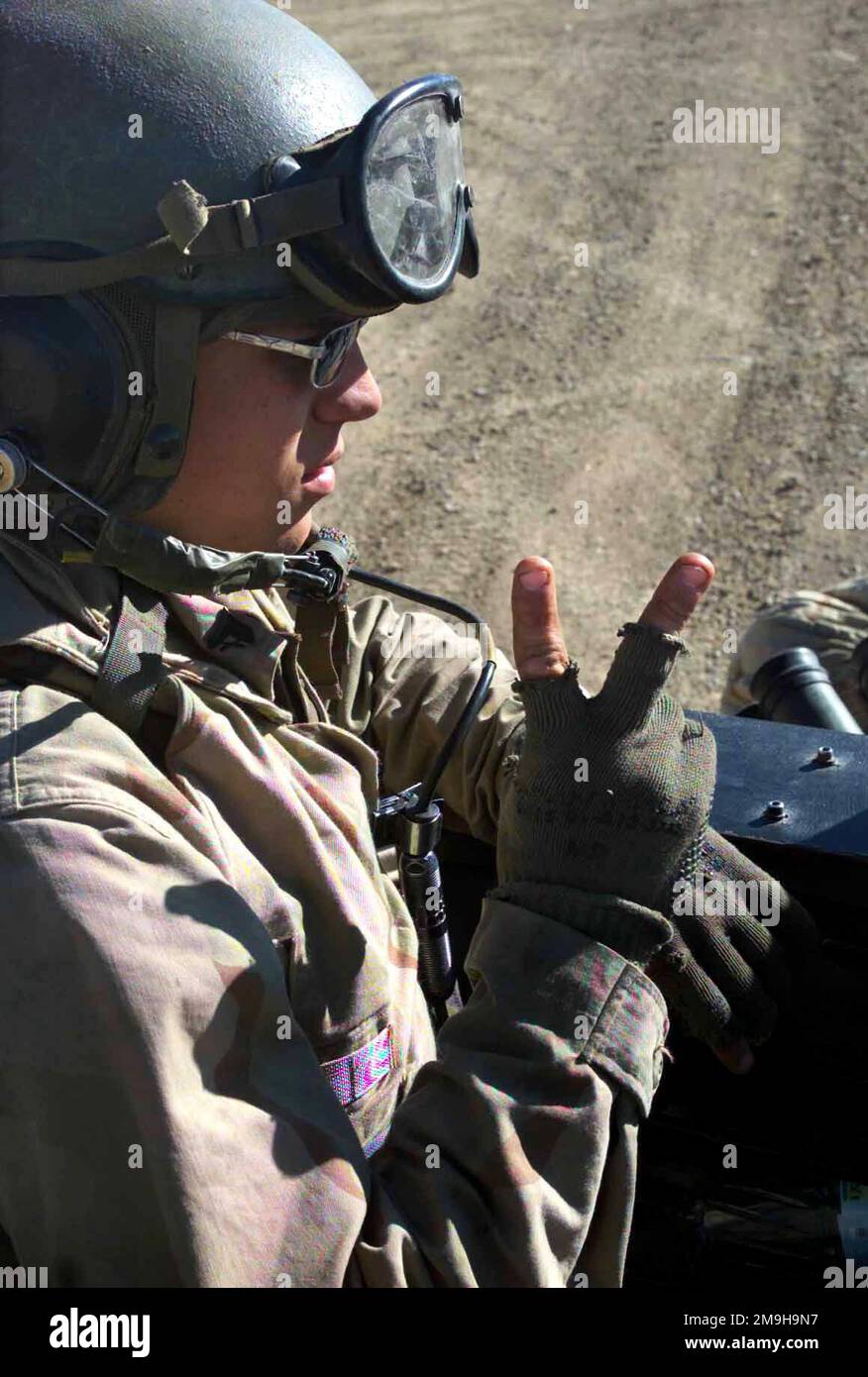 Corporal David Easter, USMC, communicates via hand signals with his ...