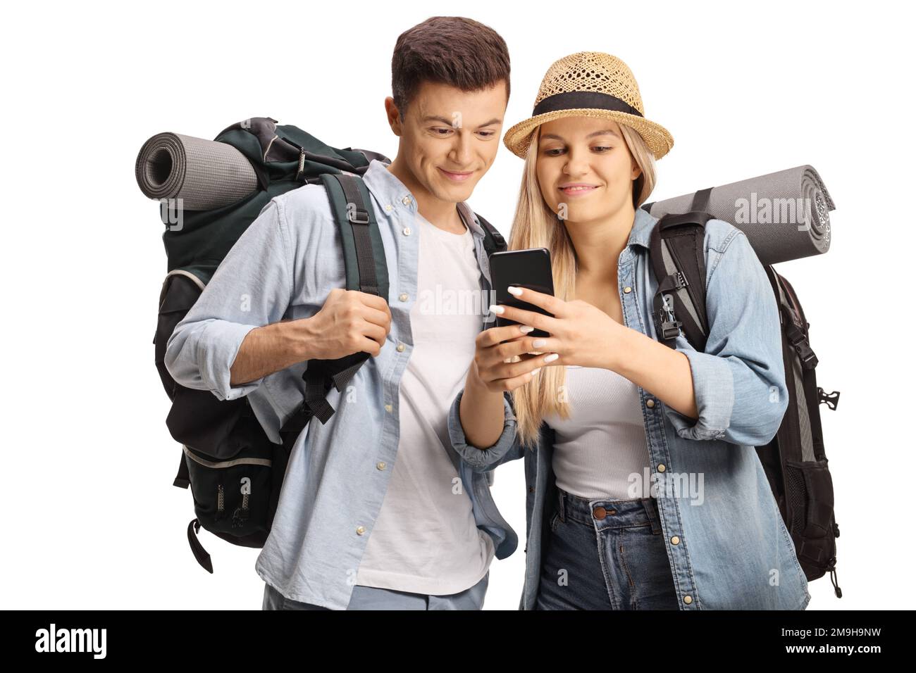 Young male and female backpackers looking at a smartphone isolated on ...