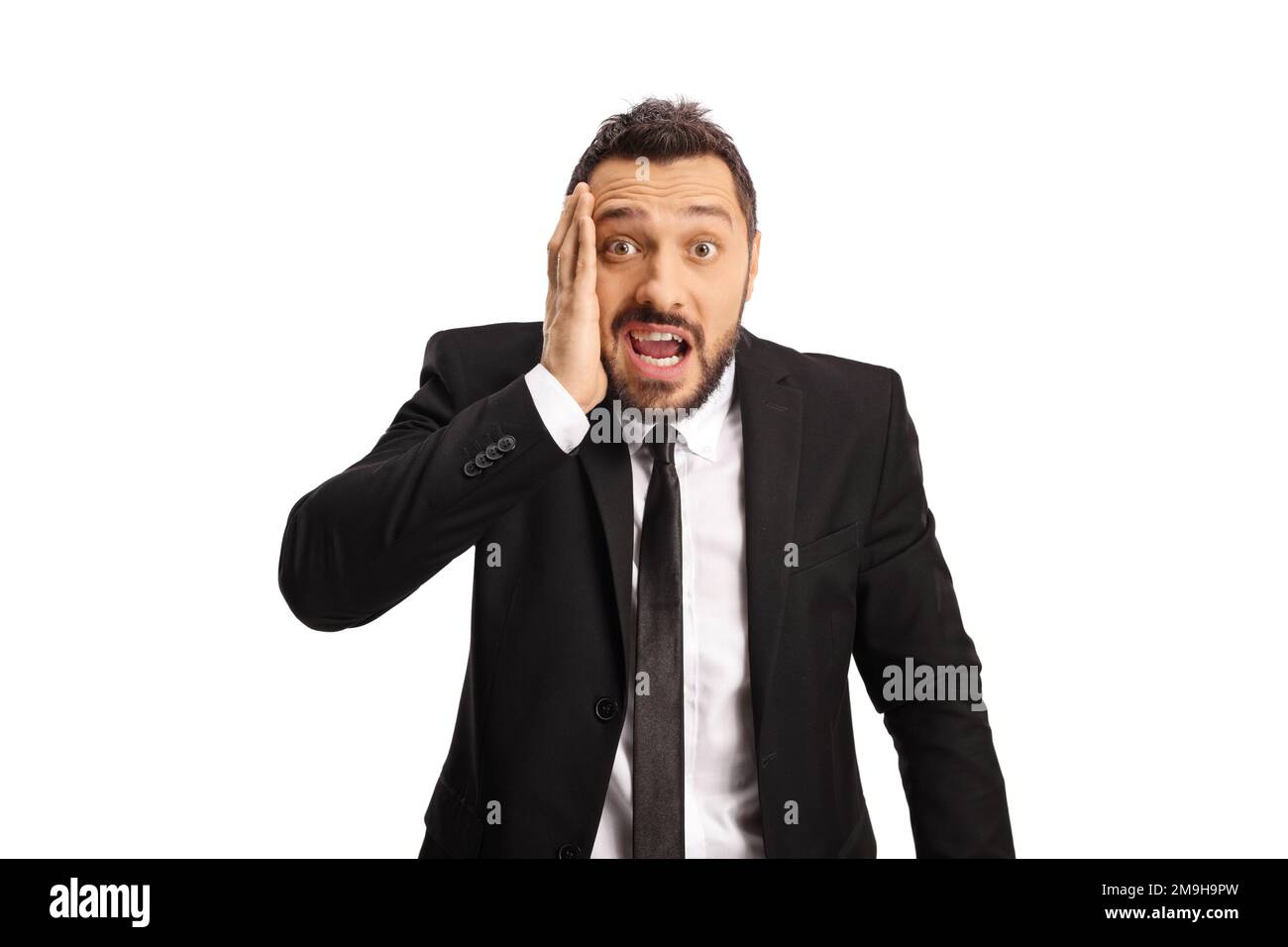 Shocked businessman holding his cheek isolated on white background ...