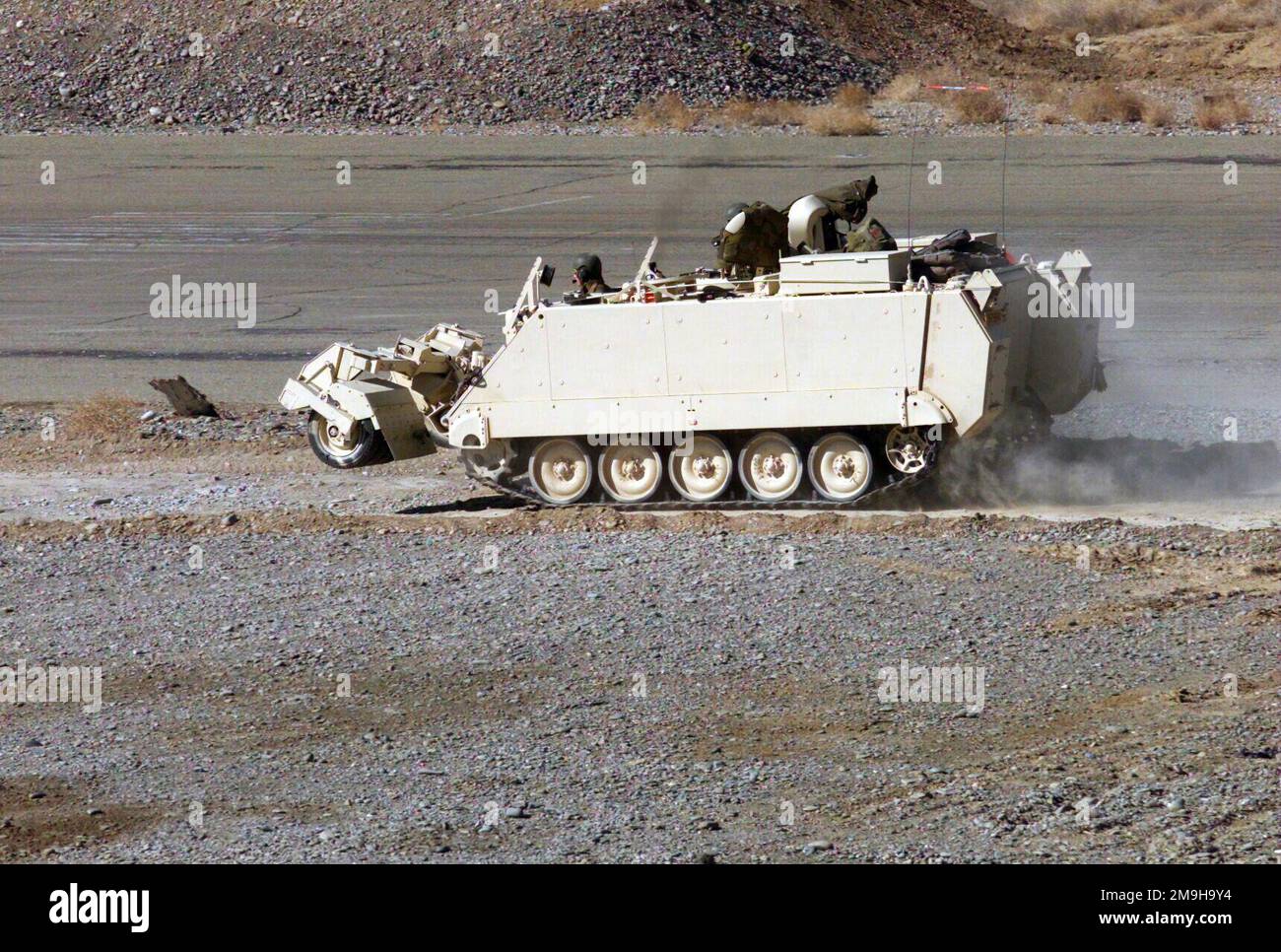 A Norwegian M113 personnel carrier with mine roller, drives along the ...