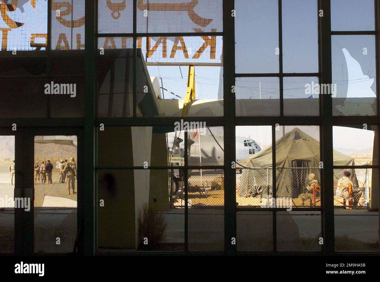 Looking outside the passenger terminal a Marine KC-130 Hercules taxies ...