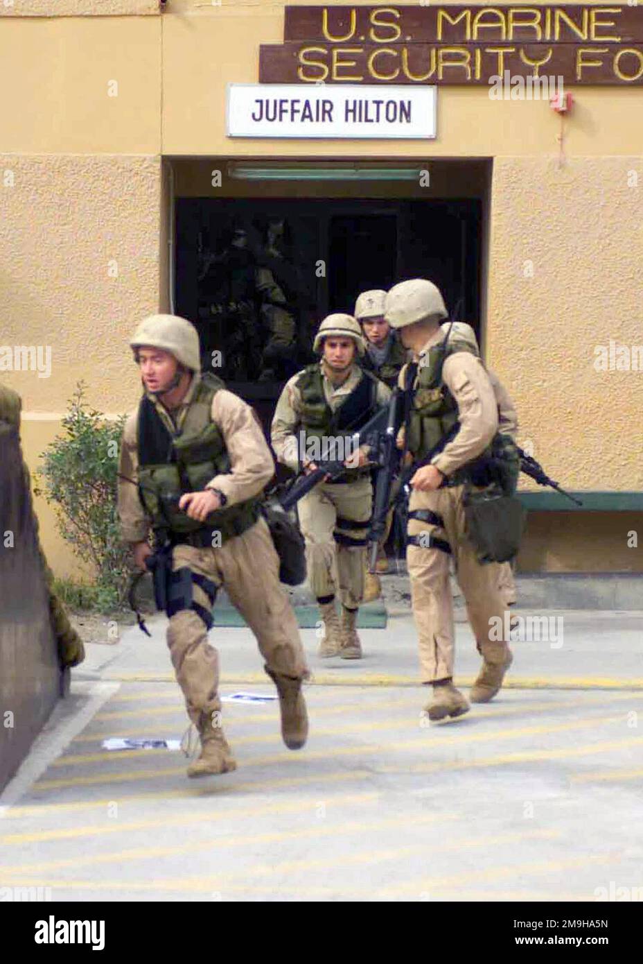 SGT David M. Simons, USMC, leads his team out of the Marine Security ...