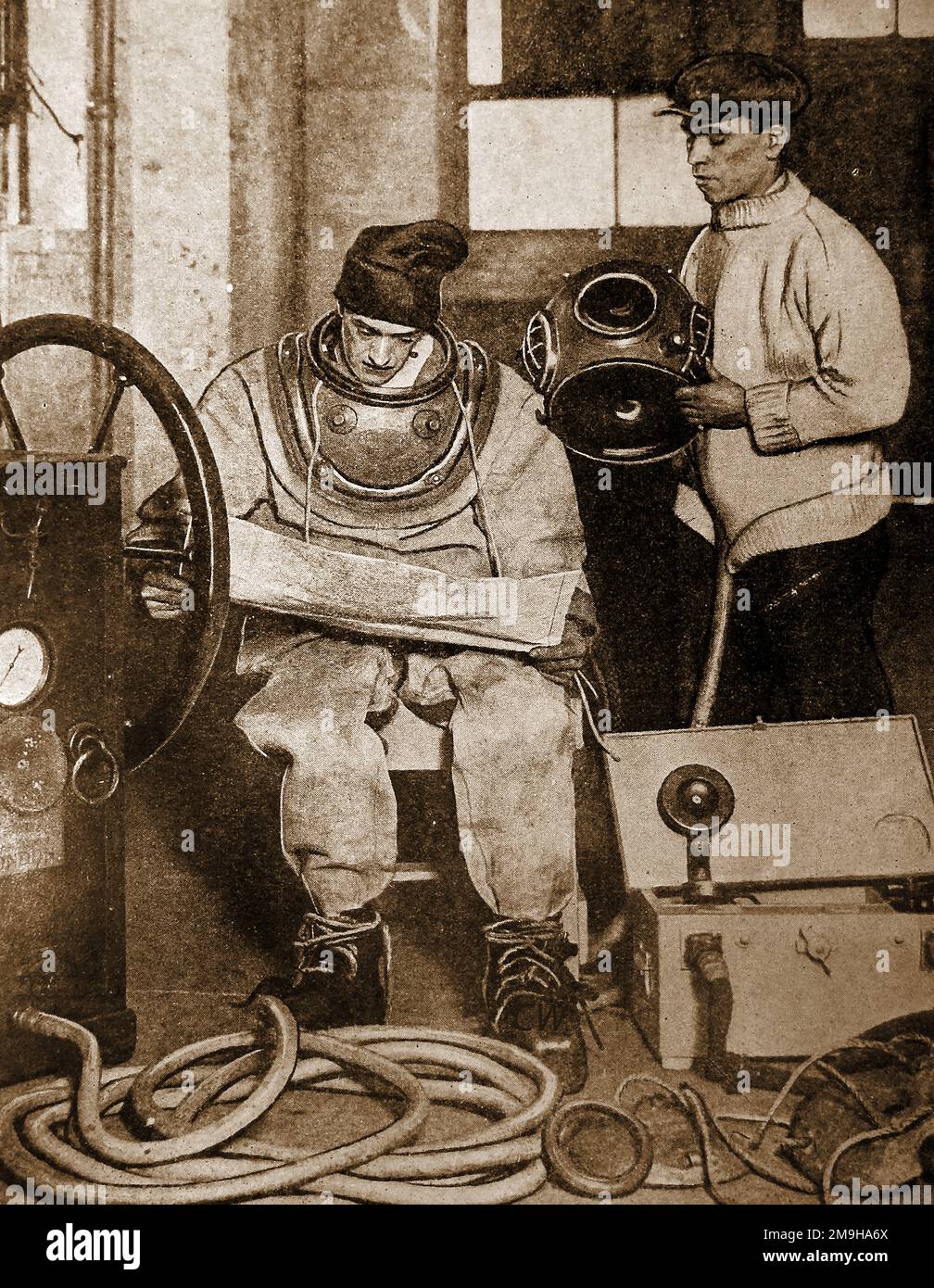 A 1930 British diver with his equipment including telephone, air pump ...