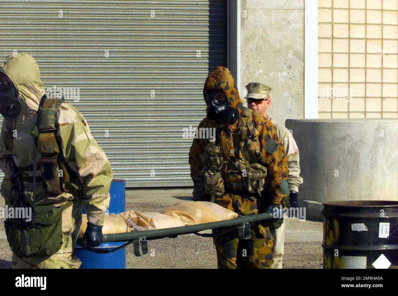 A Marine, left, in his Joint Service Lightweight Integrated Suit ...