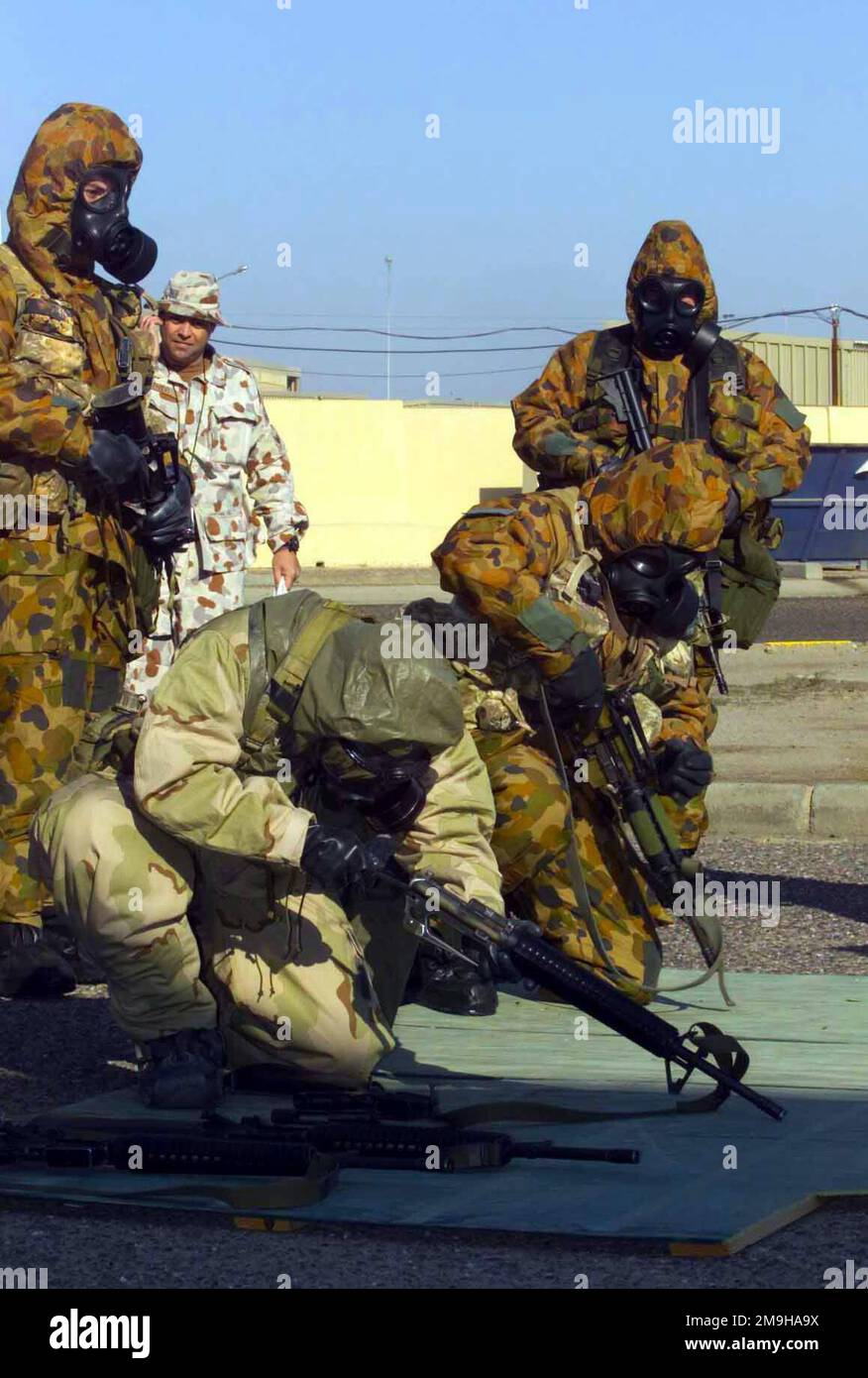 A Marine, foreground, from the Combined Joint Task Force (CJTF) along ...