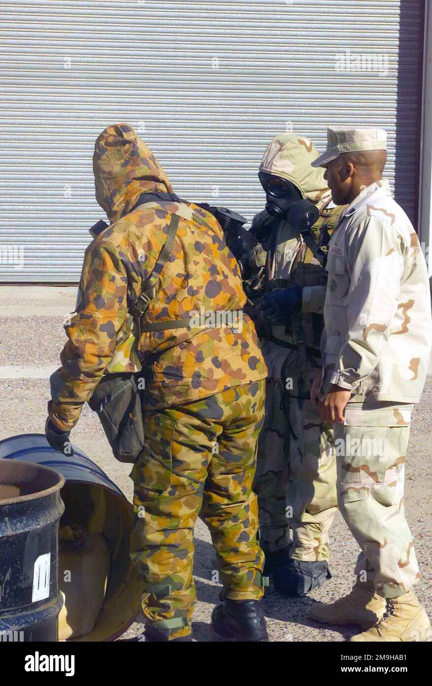 Working in full NBC (Nuclear Biological Chemical) gear, a Marine and ...