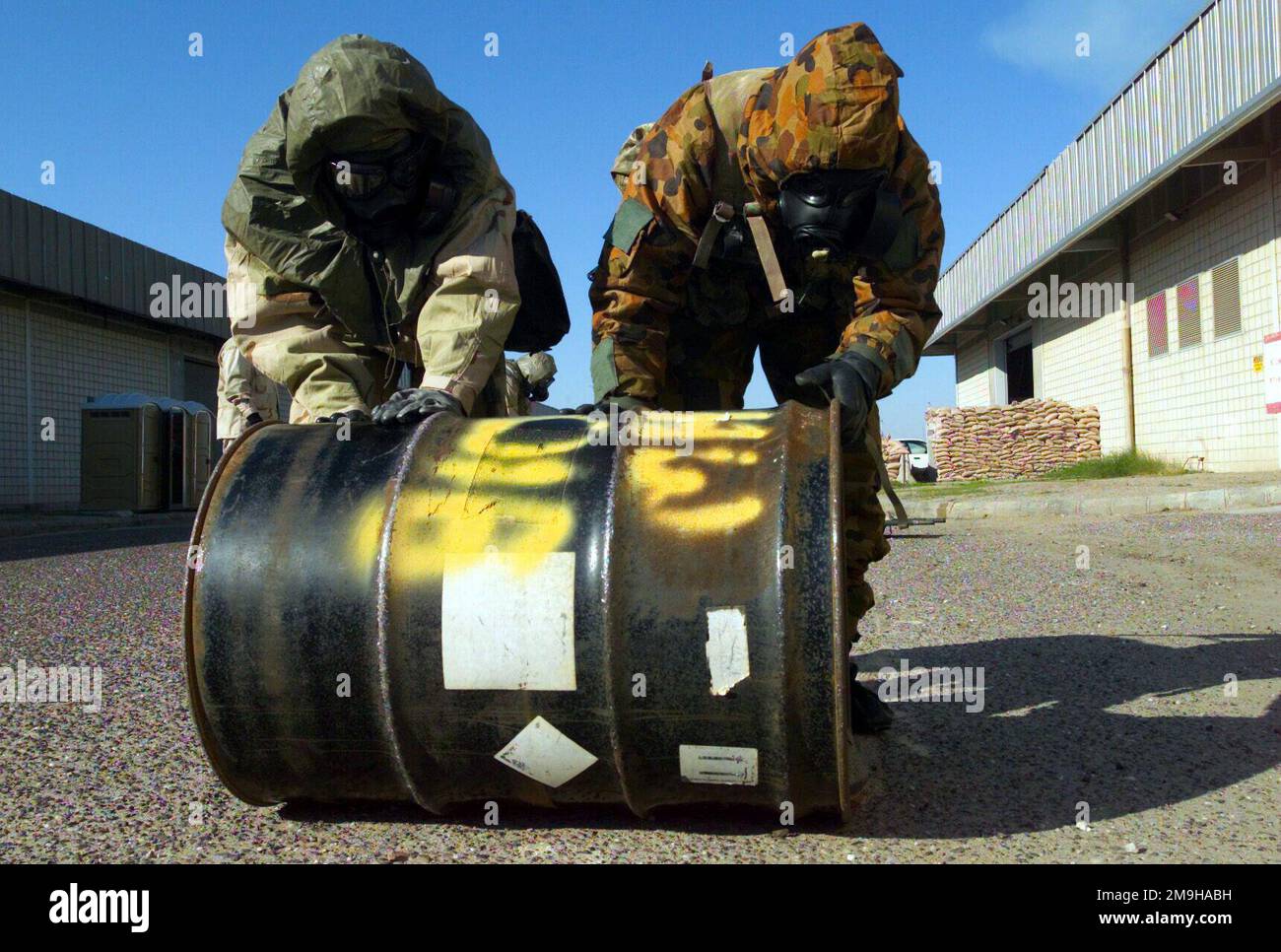 A Marine (left), in his Joint Service Lightweight Integrated Suit ...