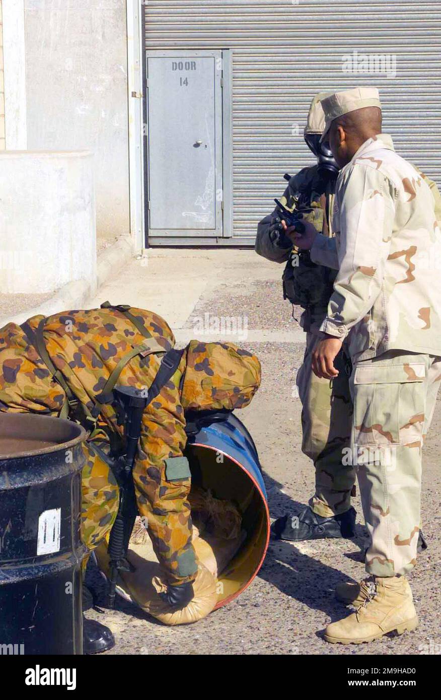 Working in full NBC (Nuclear Biological Chemical) gear, a Marine and ...