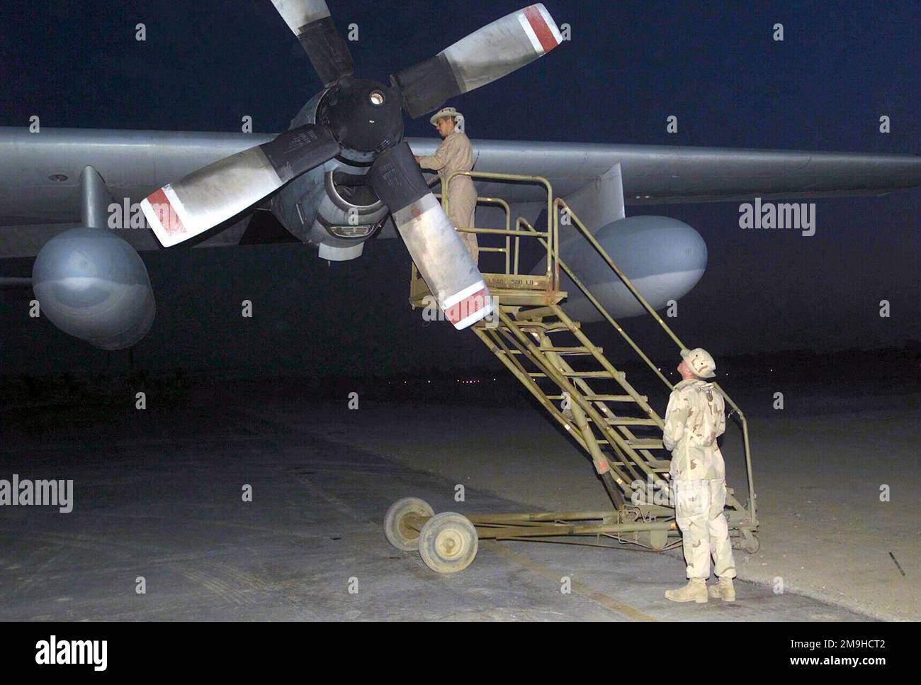 As night falls a maintenance Marine from the Marine Aerial Refueler ...